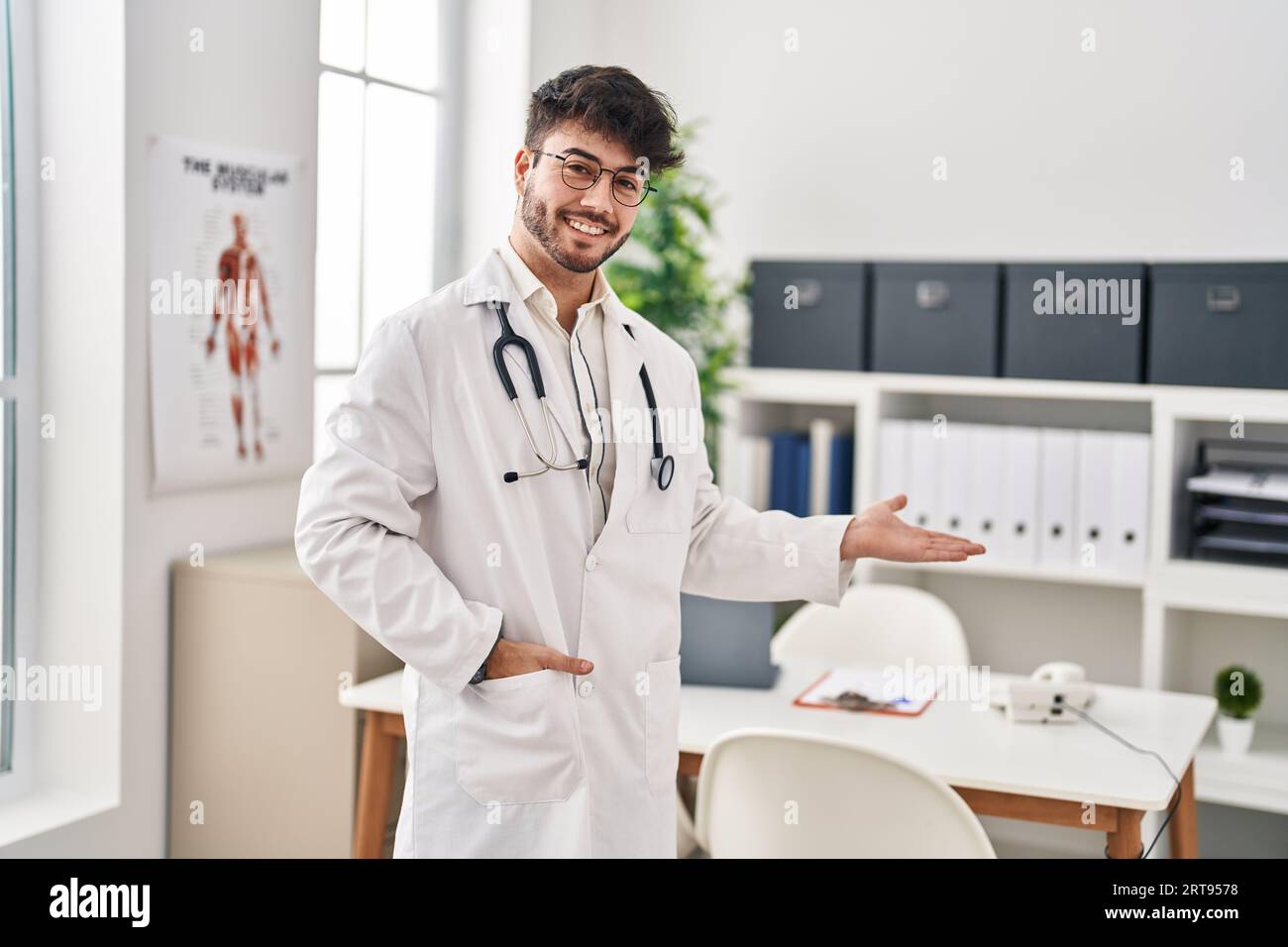Young hispanic man wearing doctor uniform doing welcome gesture with ...