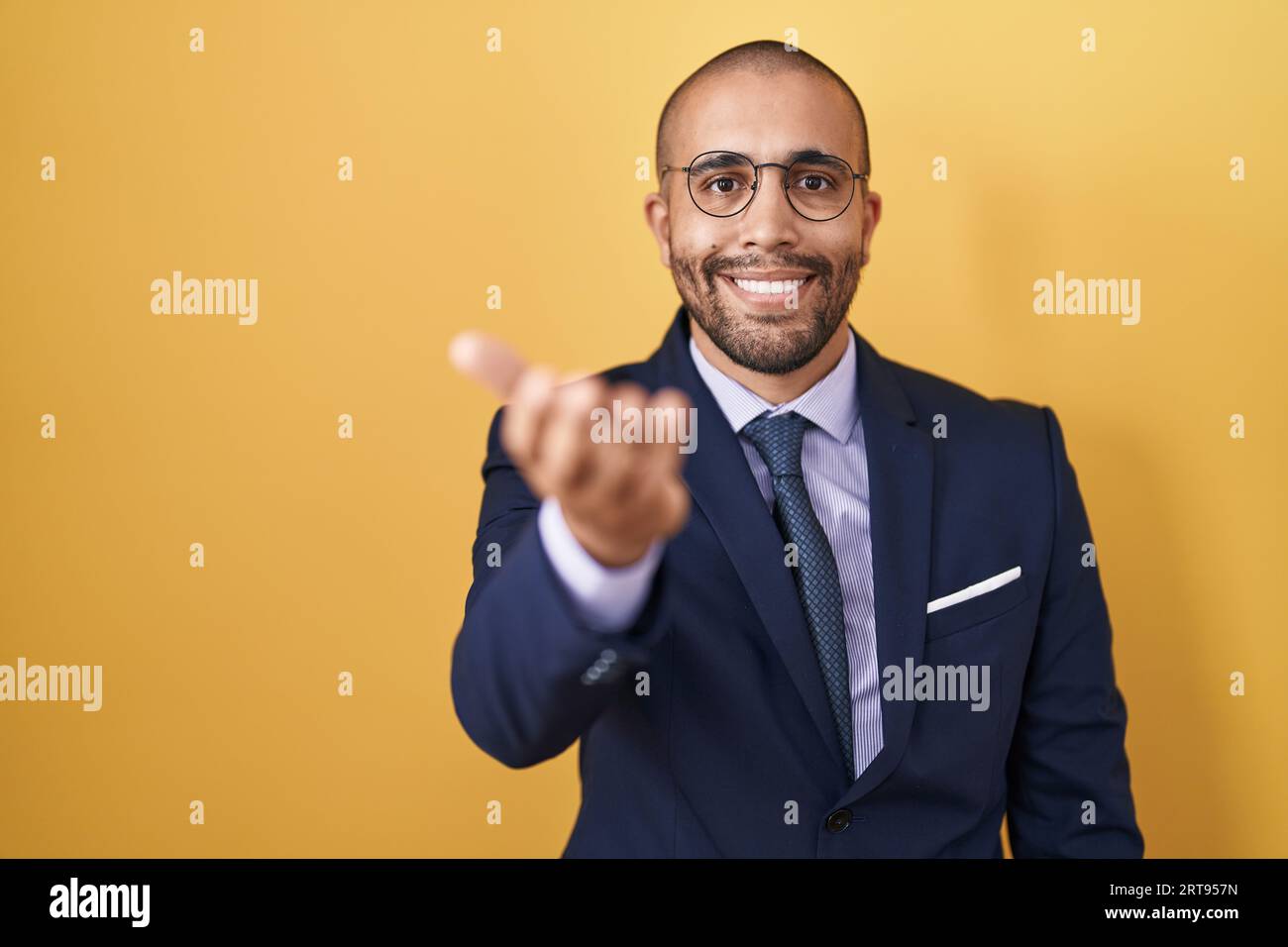 Hispanic man with beard wearing suit and tie smiling friendly offering ...