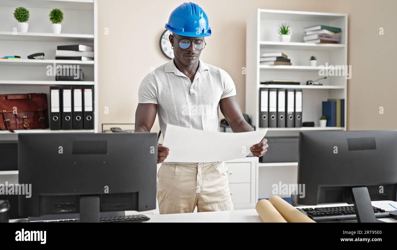 African american man architect looking house project thinking at the ...