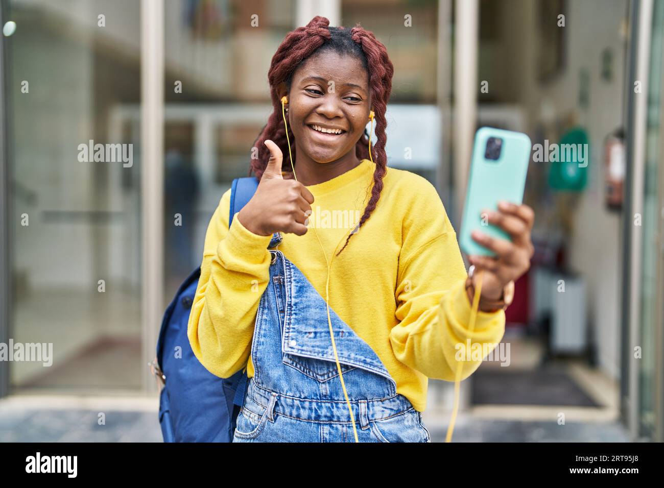 African woman doing video call with smartphone smiling happy and ...