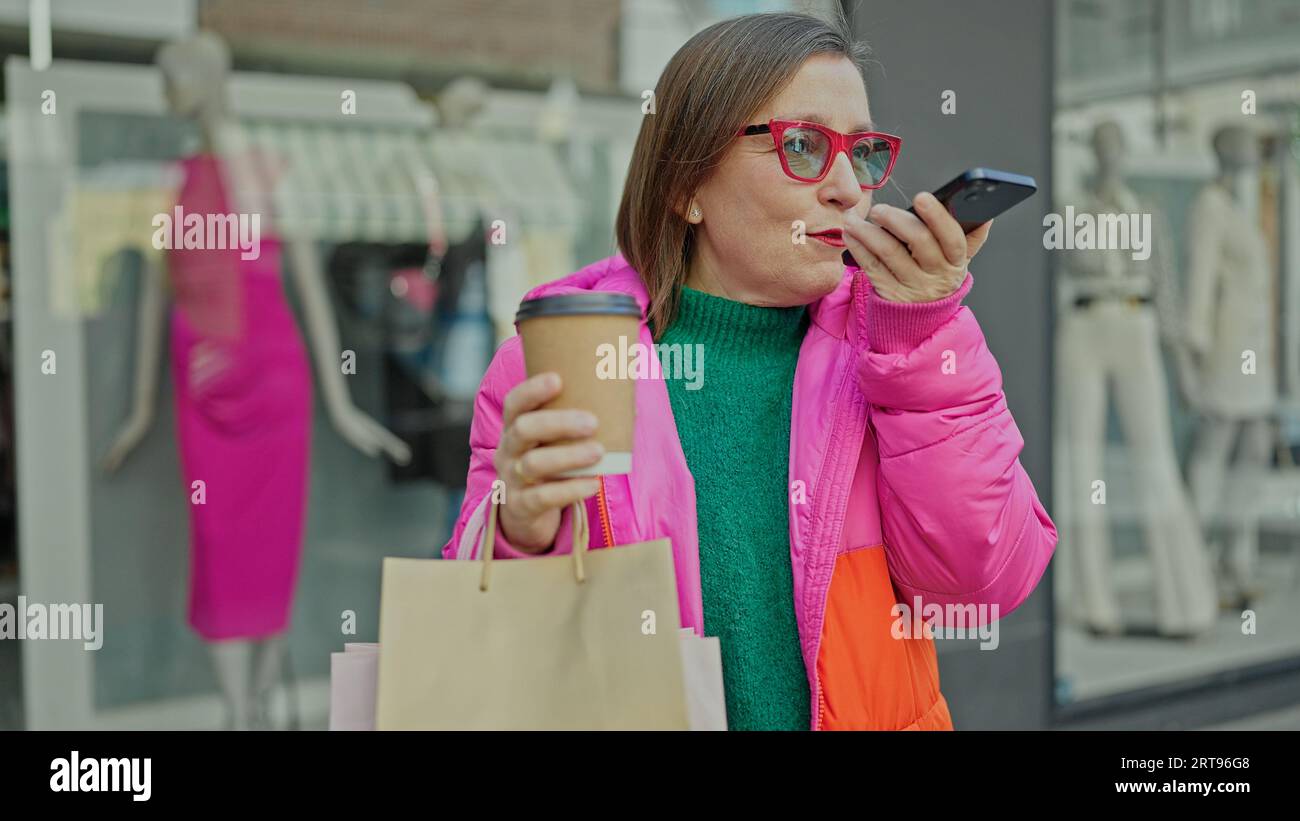 Mature hispanic woman with grey hair smiling going shopping sending ...