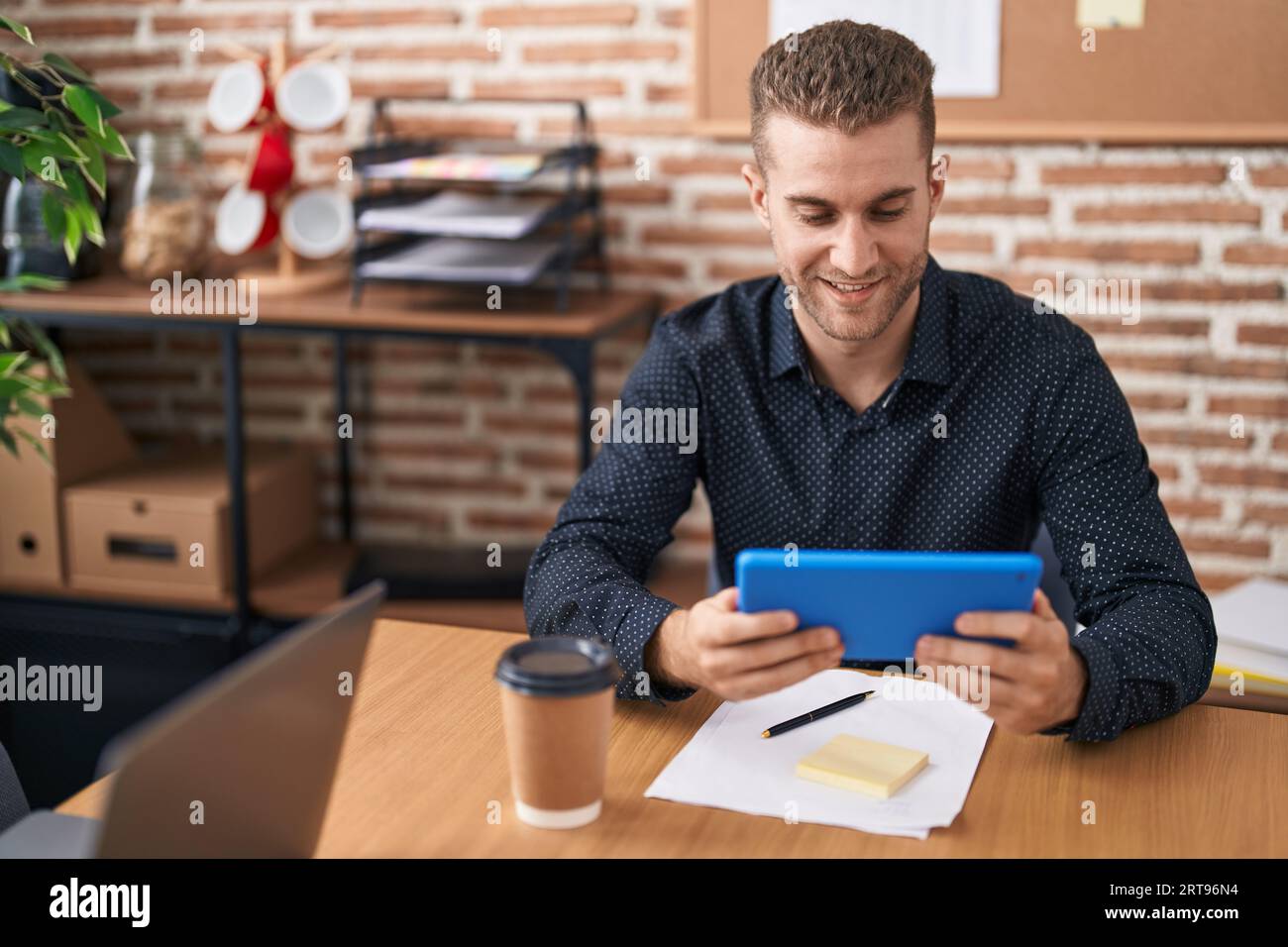 Young caucasian man business worker using touchpad working at office ...