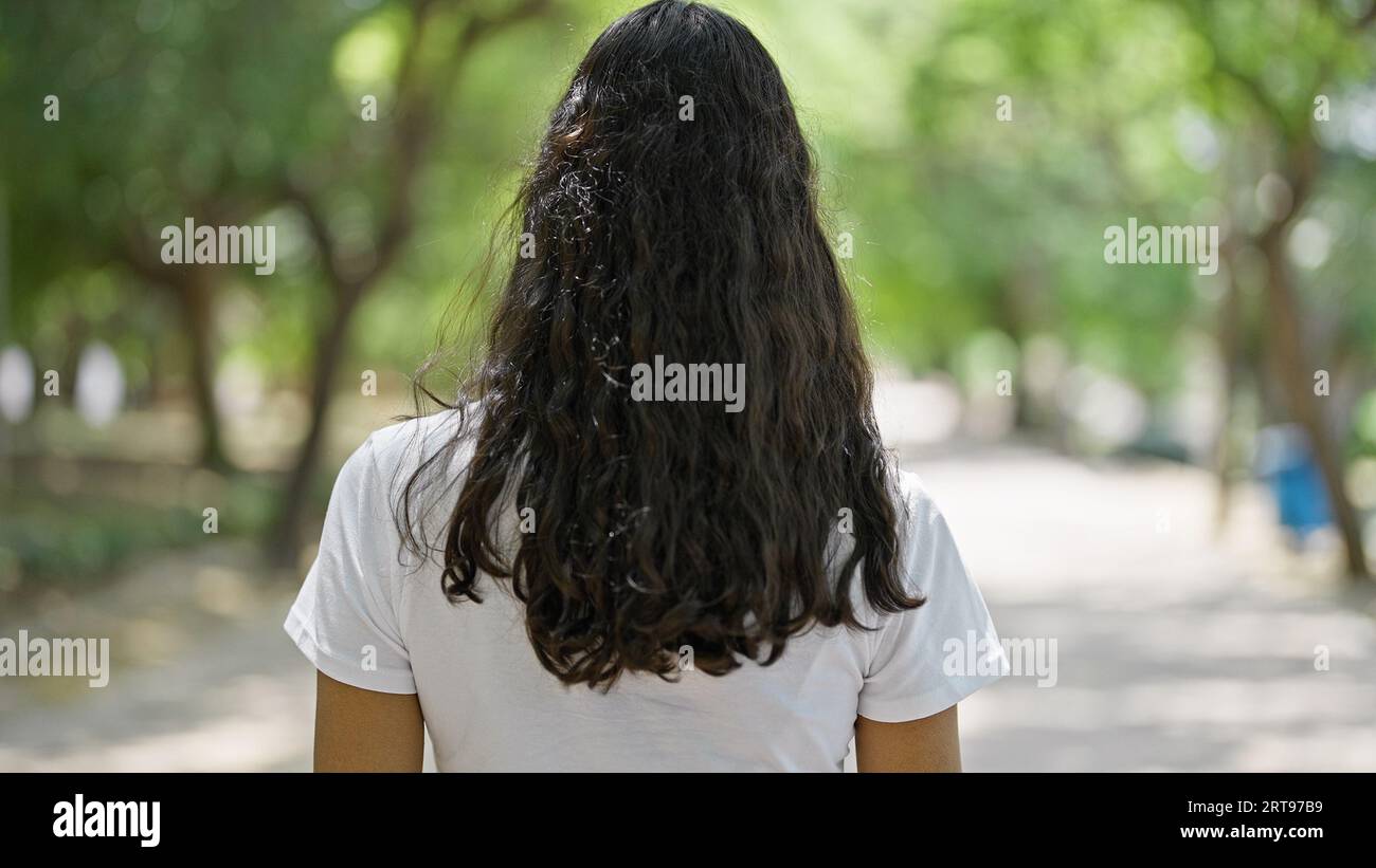 African american woman standing backwards at park Stock Photo - Alamy