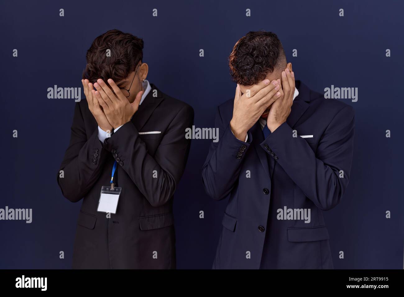 Two hispanic business men wearing business clothes with sad expression ...