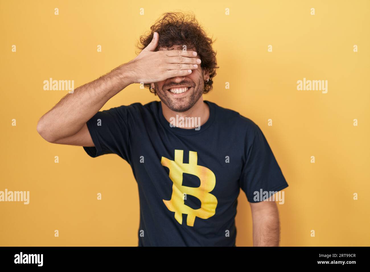 Hispanic young man wearing bitcoin t shirt smiling and laughing with ...