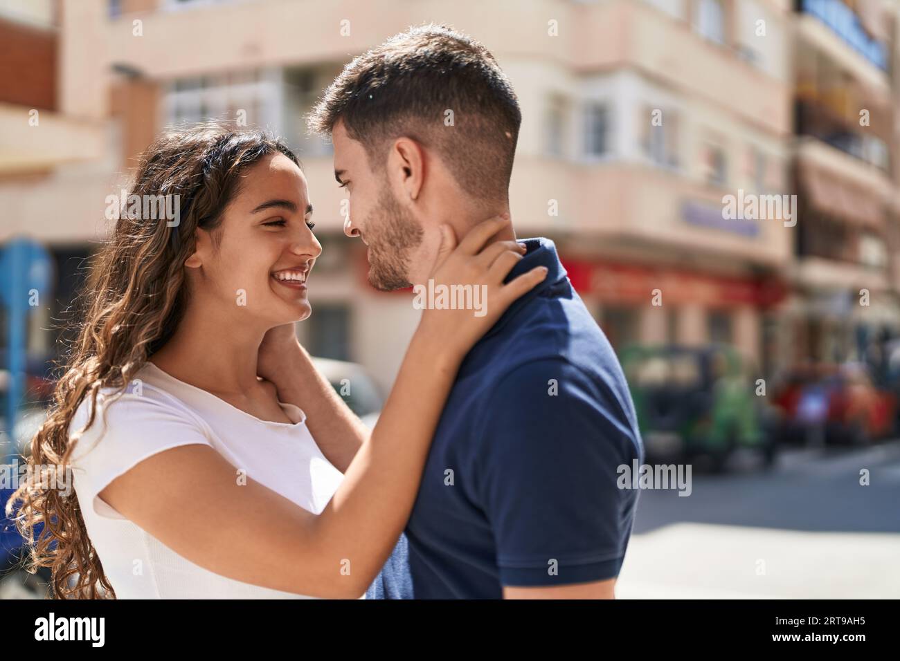 Young hispanic couple smiling confident hugging each other at street ...