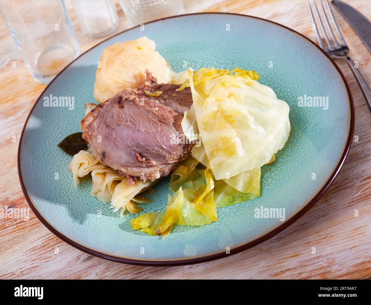 Spanish traditional dish - pork cheeks with cabbage Stock Photo - Alamy