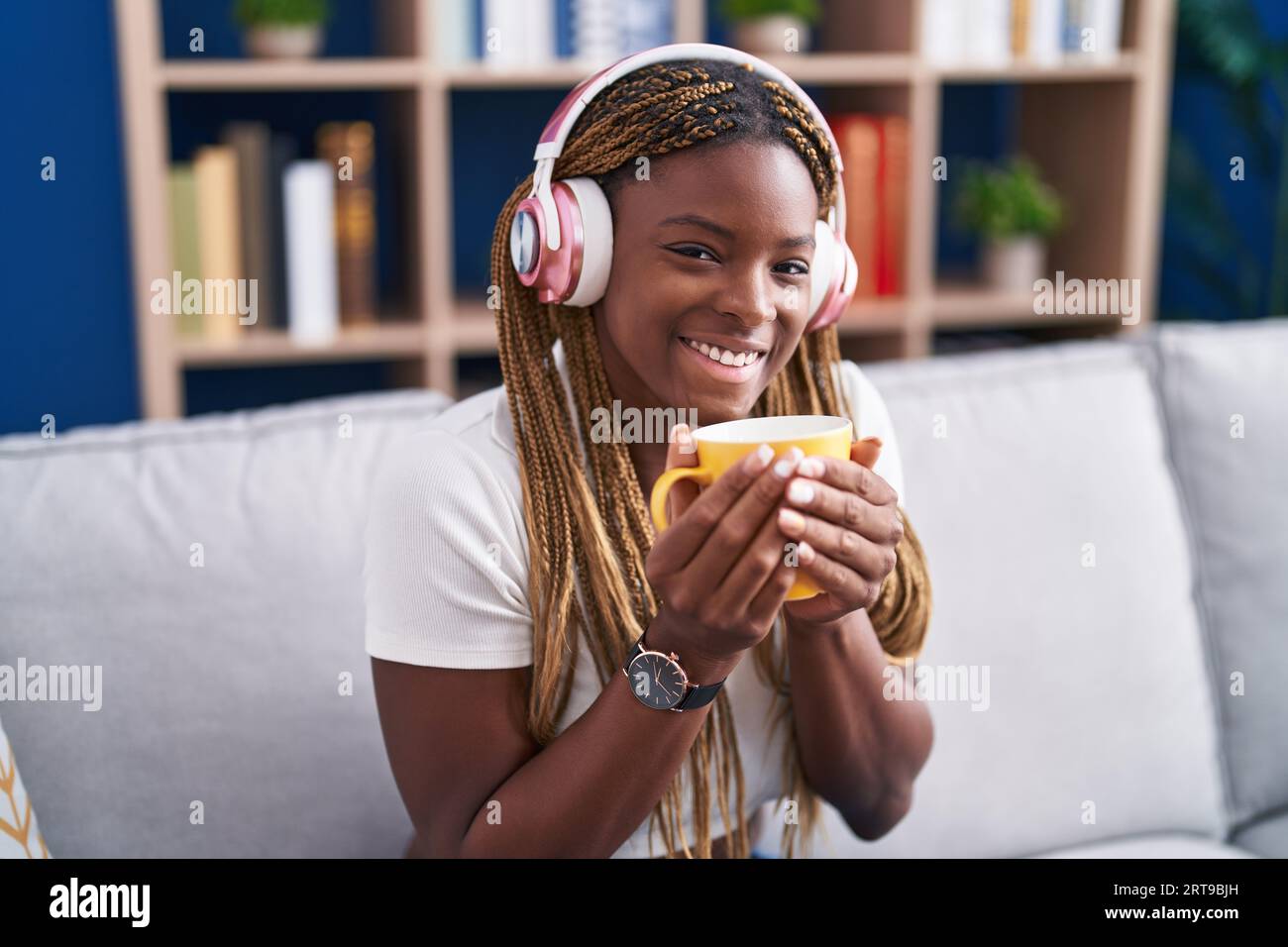African american woman listening to music drinking coffee at home Stock ...