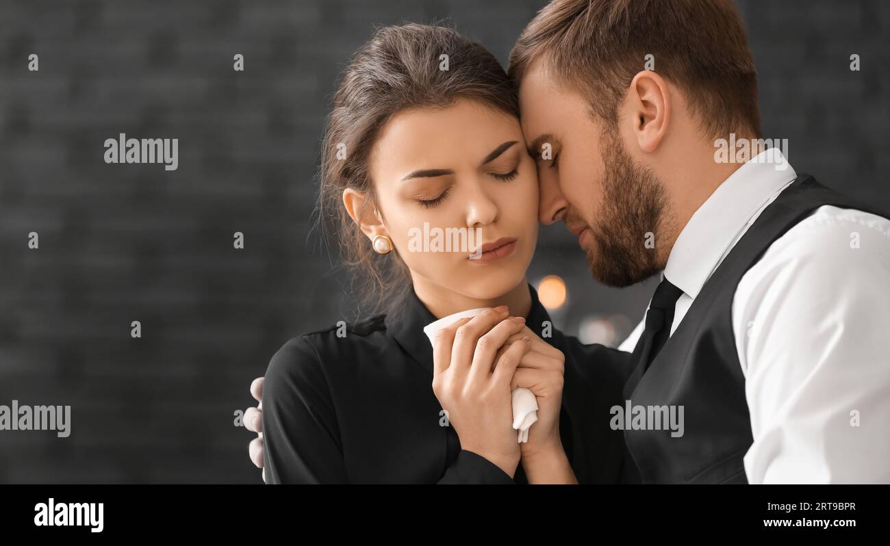 Couple pining after their relative at funeral Stock Photo - Alamy