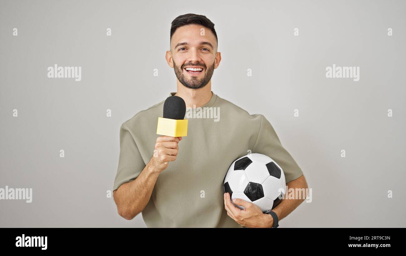 Young hispanic man soccer reporter working using microphone holding ...