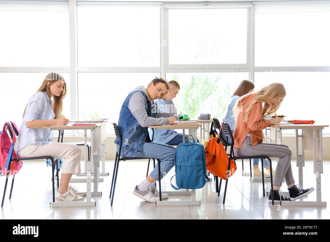 Group of classmates sitting in classroom Stock Photo - Alamy