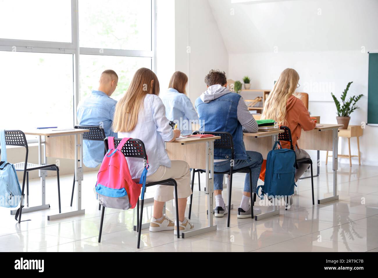 Group of classmates sitting in classroom Stock Photo - Alamy