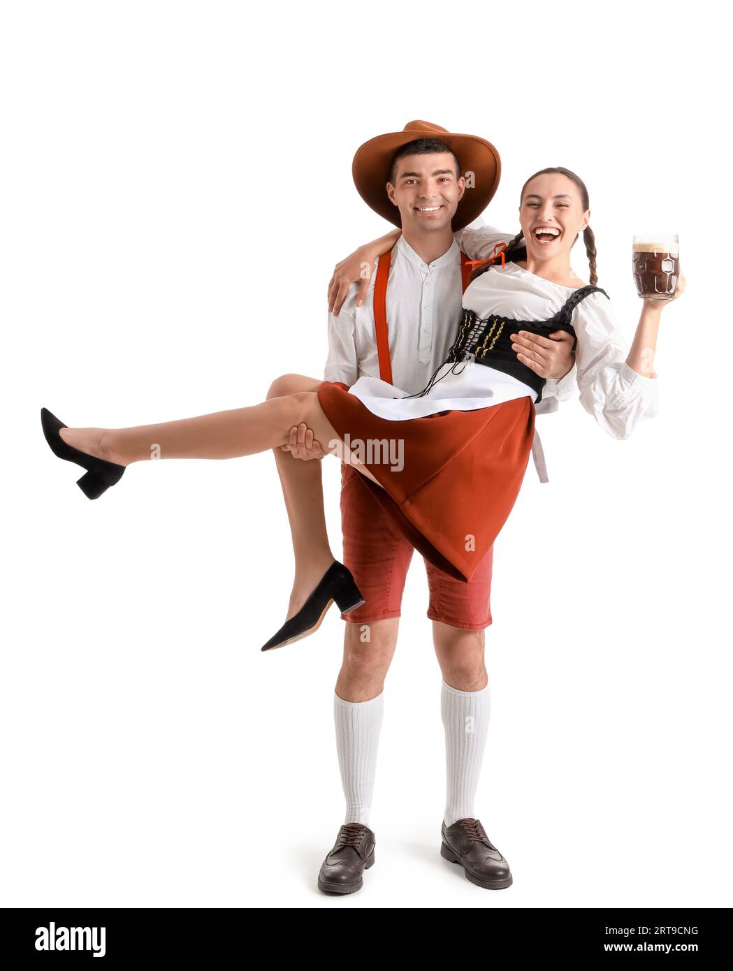 Young couple in traditional German clothes with beer on white ...