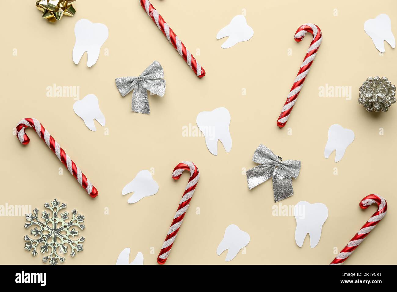Paper teeth with Christmas decor on beige background Stock Photo - Alamy