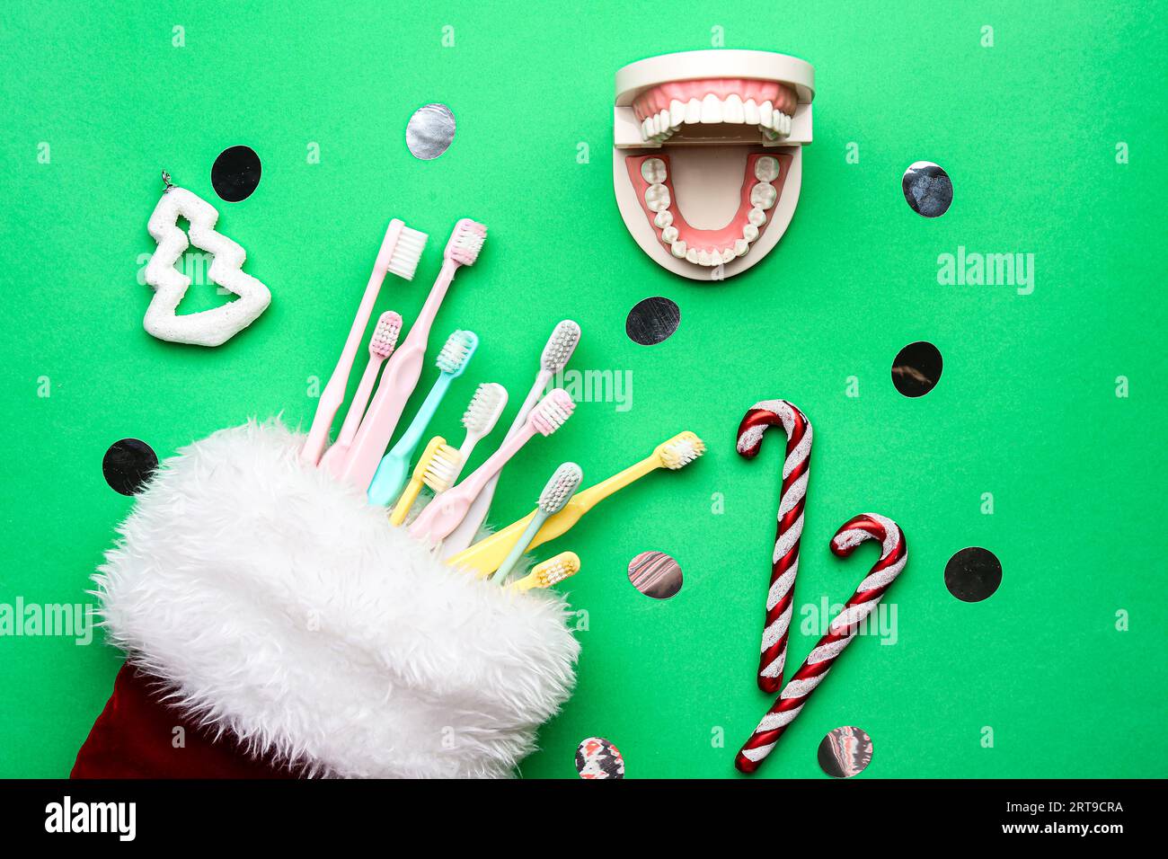 Christmas sock with toothbrushes, jaw model and decor on green ...