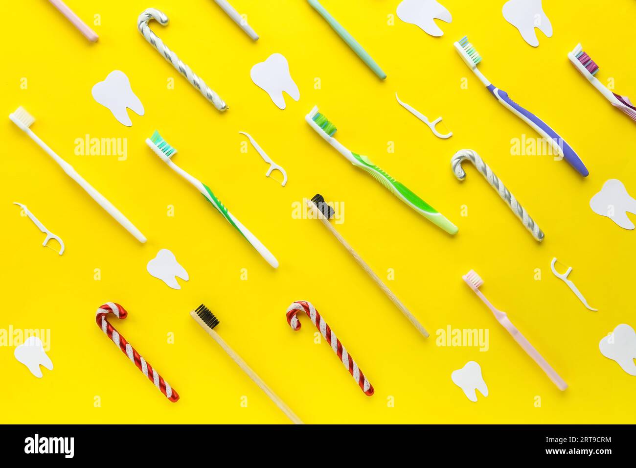 Toothbrushes with floss toothpicks, paper teeth and candy canes on ...