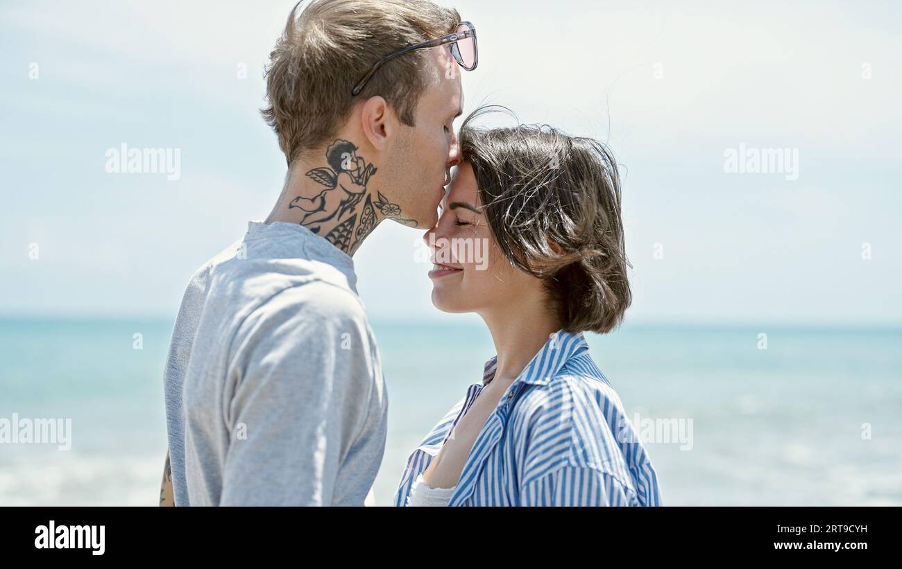 Beautiful couple smiling confident kissing at seaside Stock Photo - Alamy