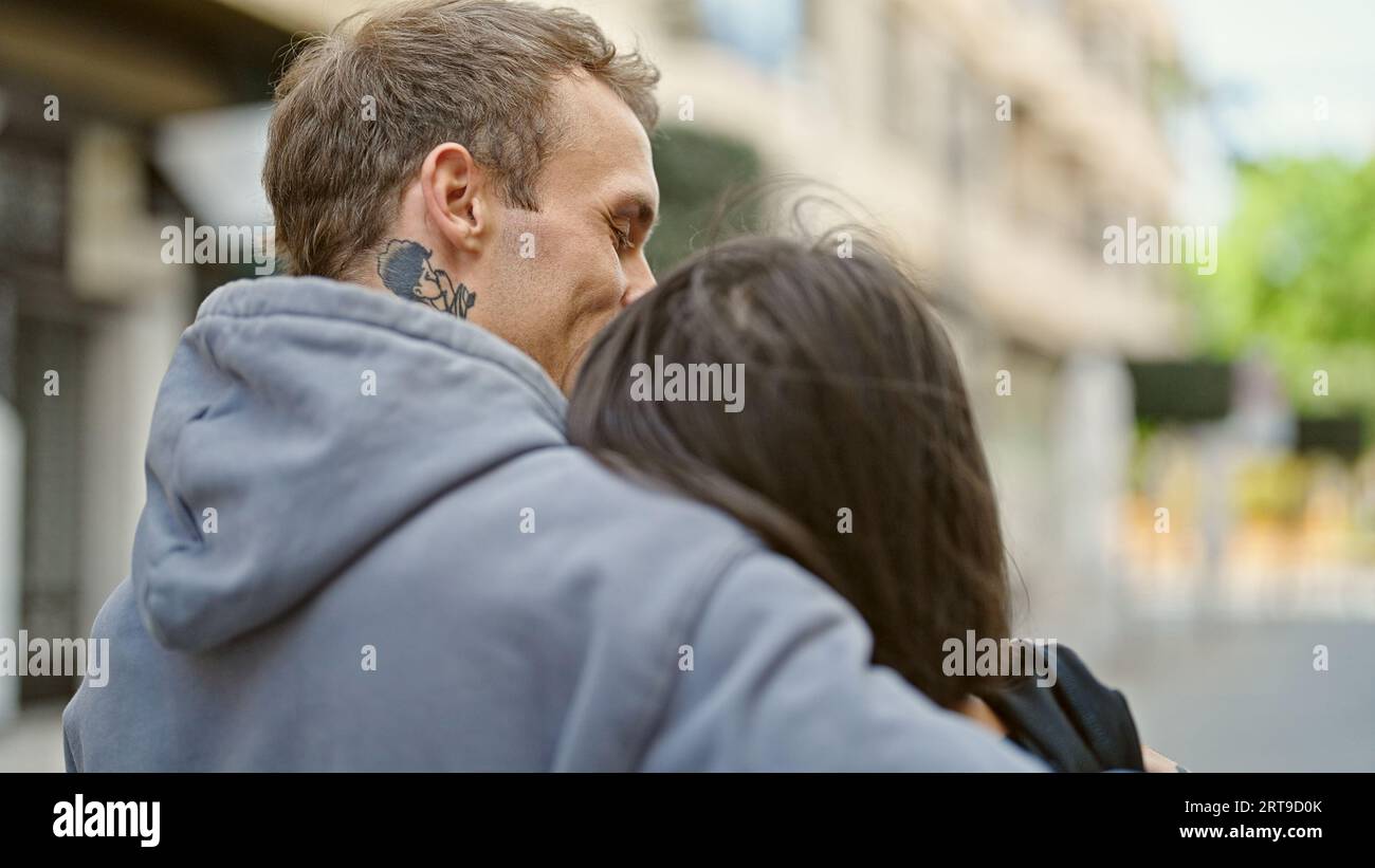 Beautiful couple hugging each other standing backwards kissing at ...