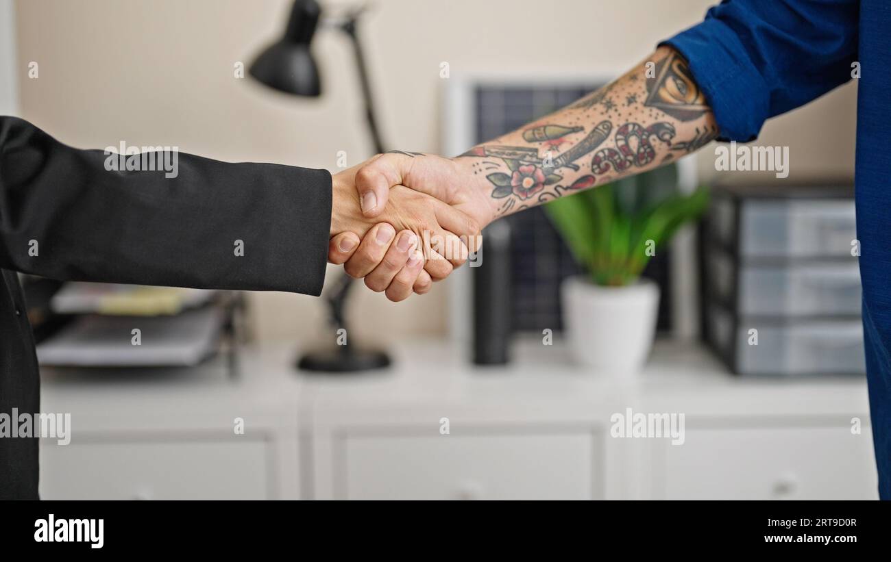 Two business workers shake hands at the office Stock Photo - Alamy