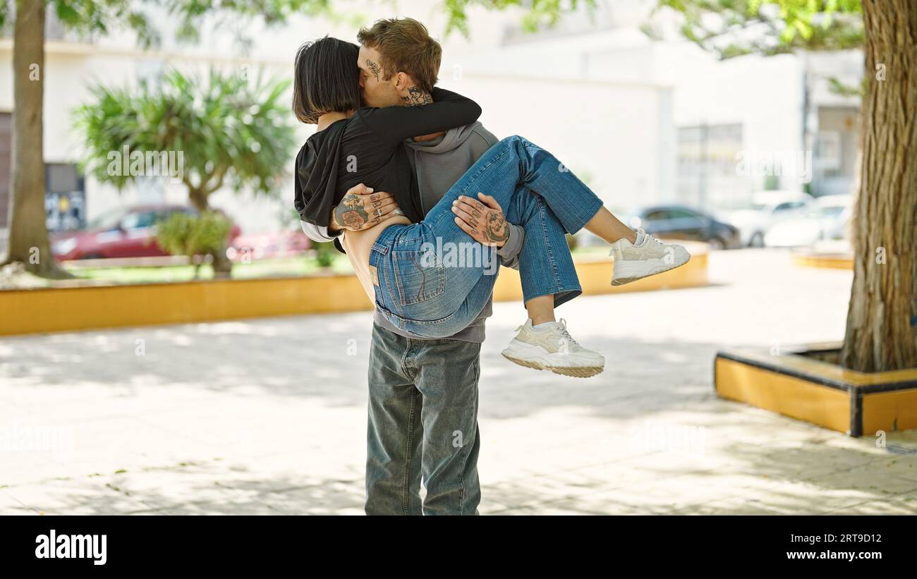 Beautiful couple smiling confident hugging each other on arms kissing ...