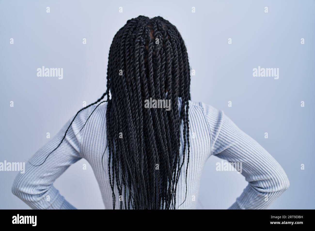 African american woman standing over blue background standing backwards ...