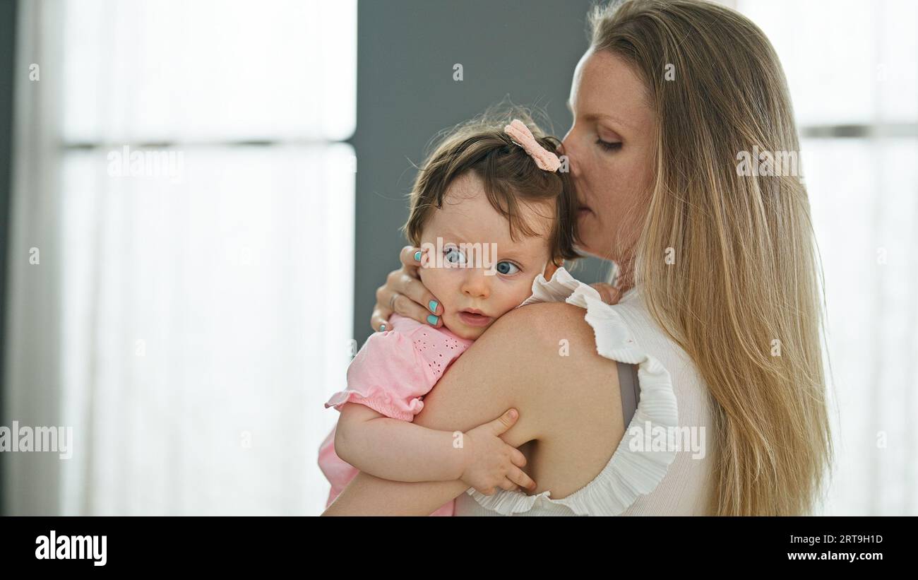 Mother and daughter hugging each other kissing at home Stock Photo - Alamy
