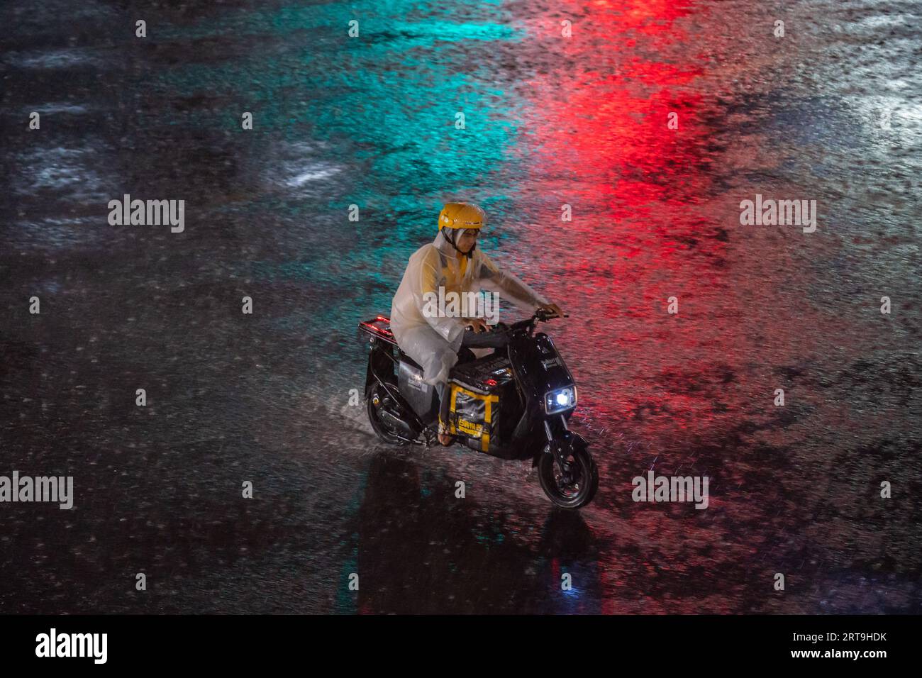 CHONGQING, CHINA - SEPTEMBER 11, 2023 A food delivery man rides in the ...