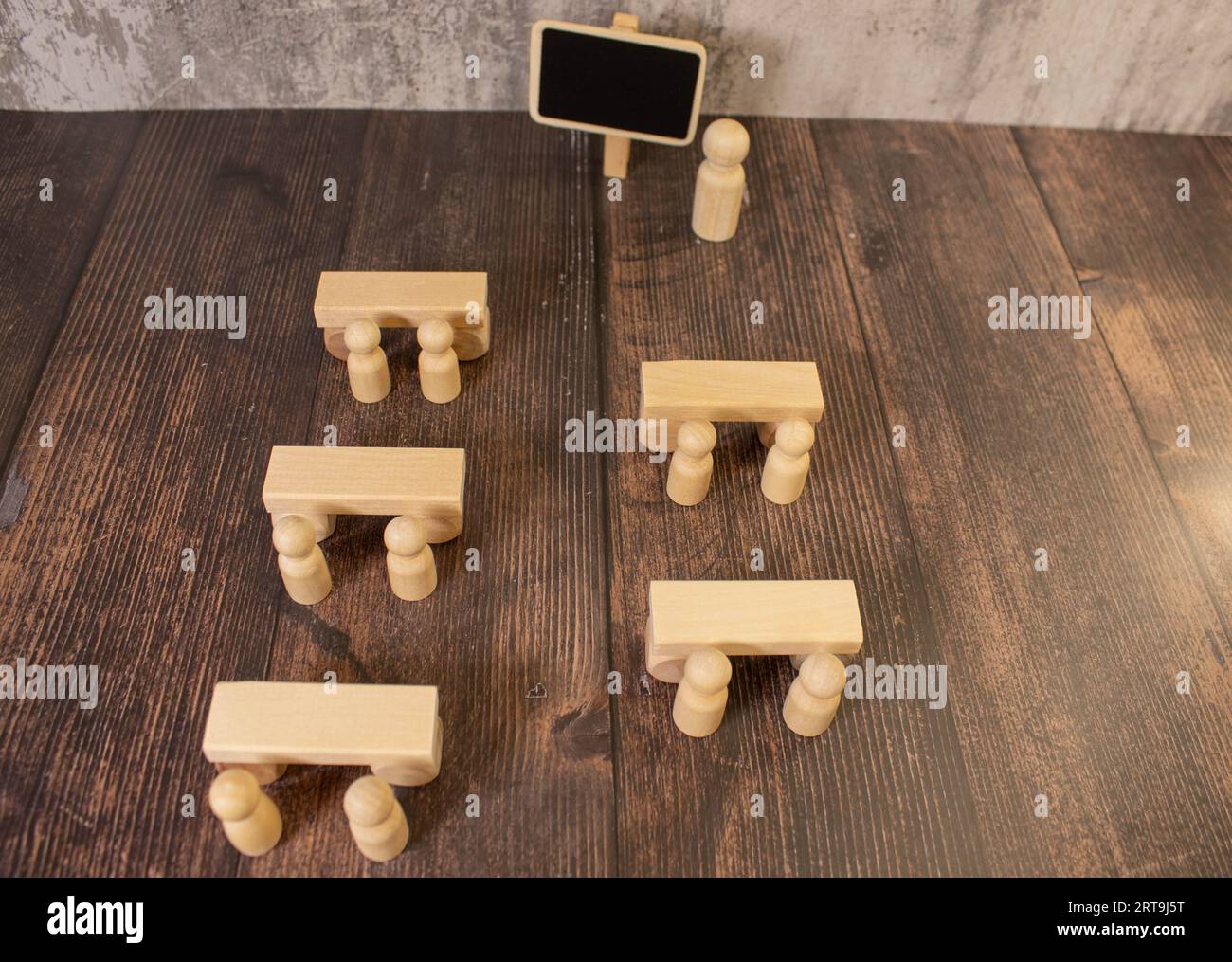 Wooden figures peg dolls stand above wooden cube among others with vote ...