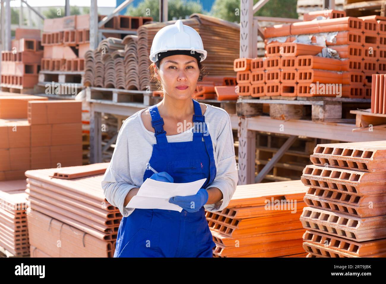 Asian woman manager keeps records of construction materials Stock Photo ...
