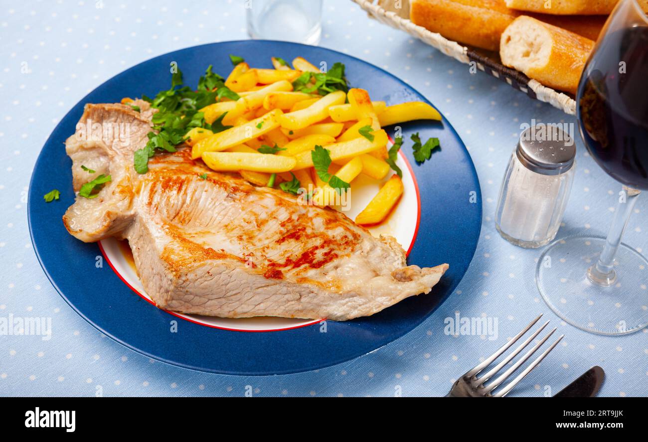 Grilled pork loin chops with french fries Stock Photo - Alamy
