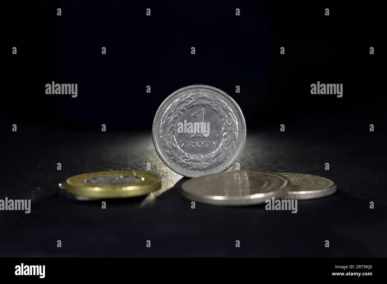 Picture of polish coin on a black background, with a focus on a coin of ...