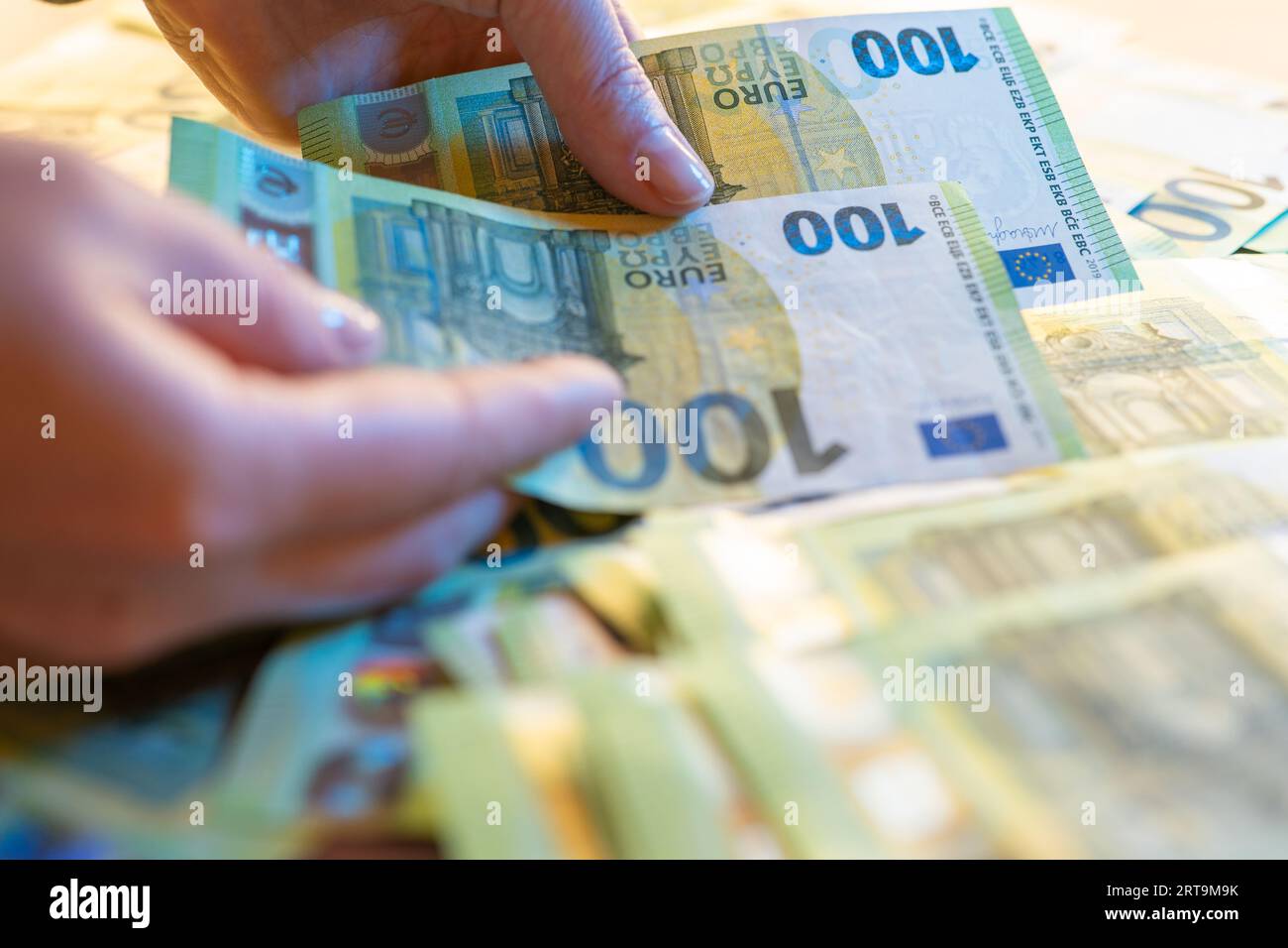 counting money.Hands collecting money.Euro currency inflation.100 euro ...