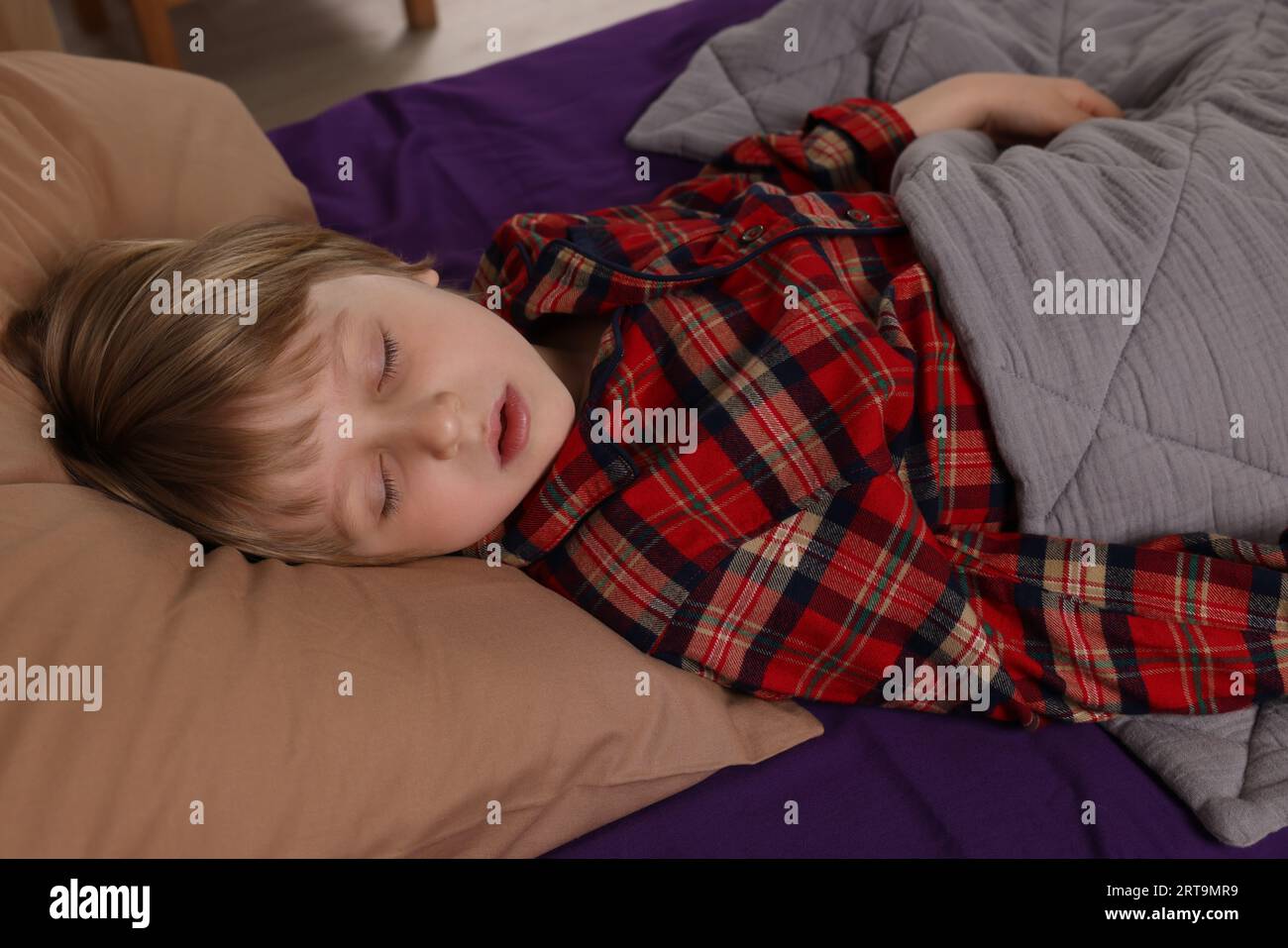 Little boy snoring while sleeping in bed Stock Photo - Alamy