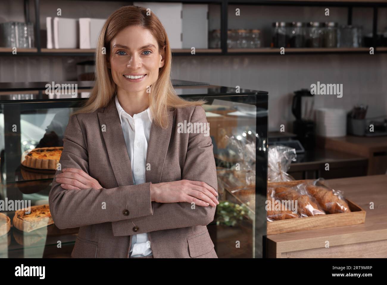 Happy business owner in bakery shop. Space for text Stock Photo - Alamy