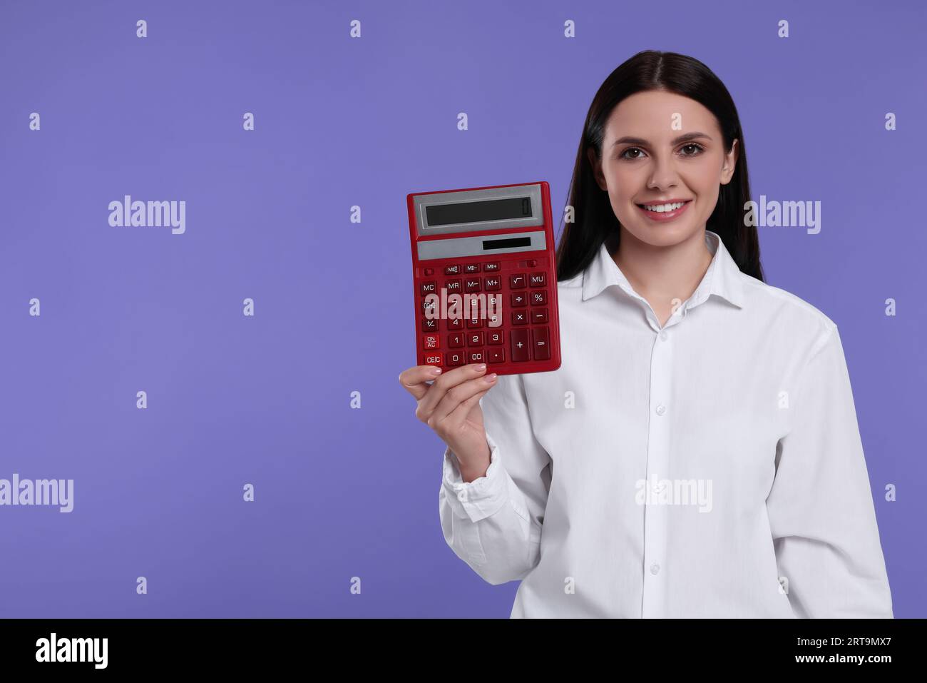 Smiling accountant with calculator on purple background, space for text ...