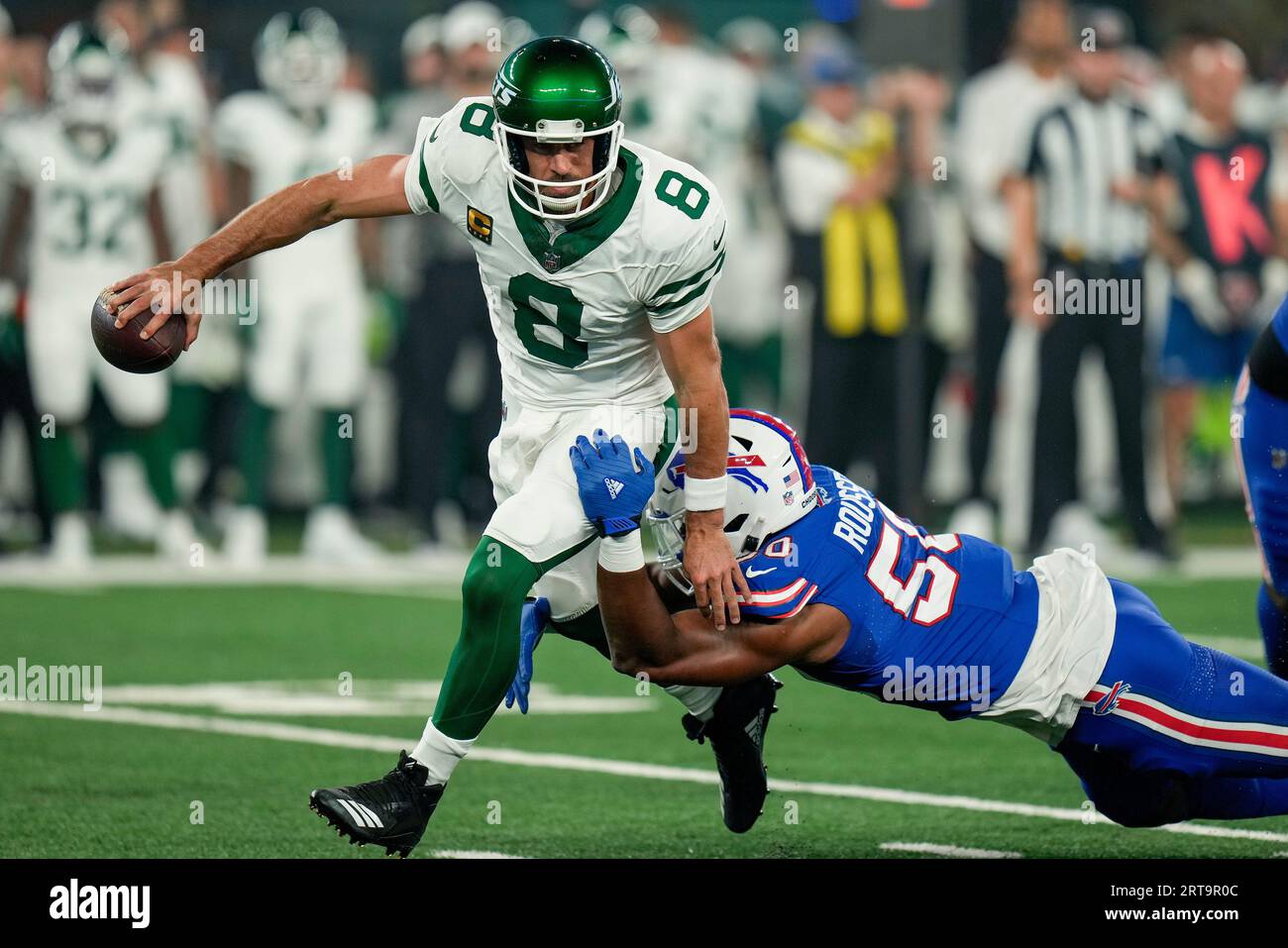 New York Jets quarterback Aaron Rodgers (8) avoids a sack from Buffalo ...