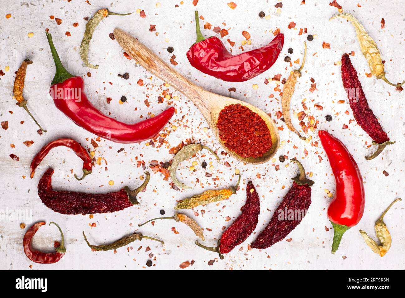 A flat lay photo of peppers in various stages. Fresh, drying, dried ...