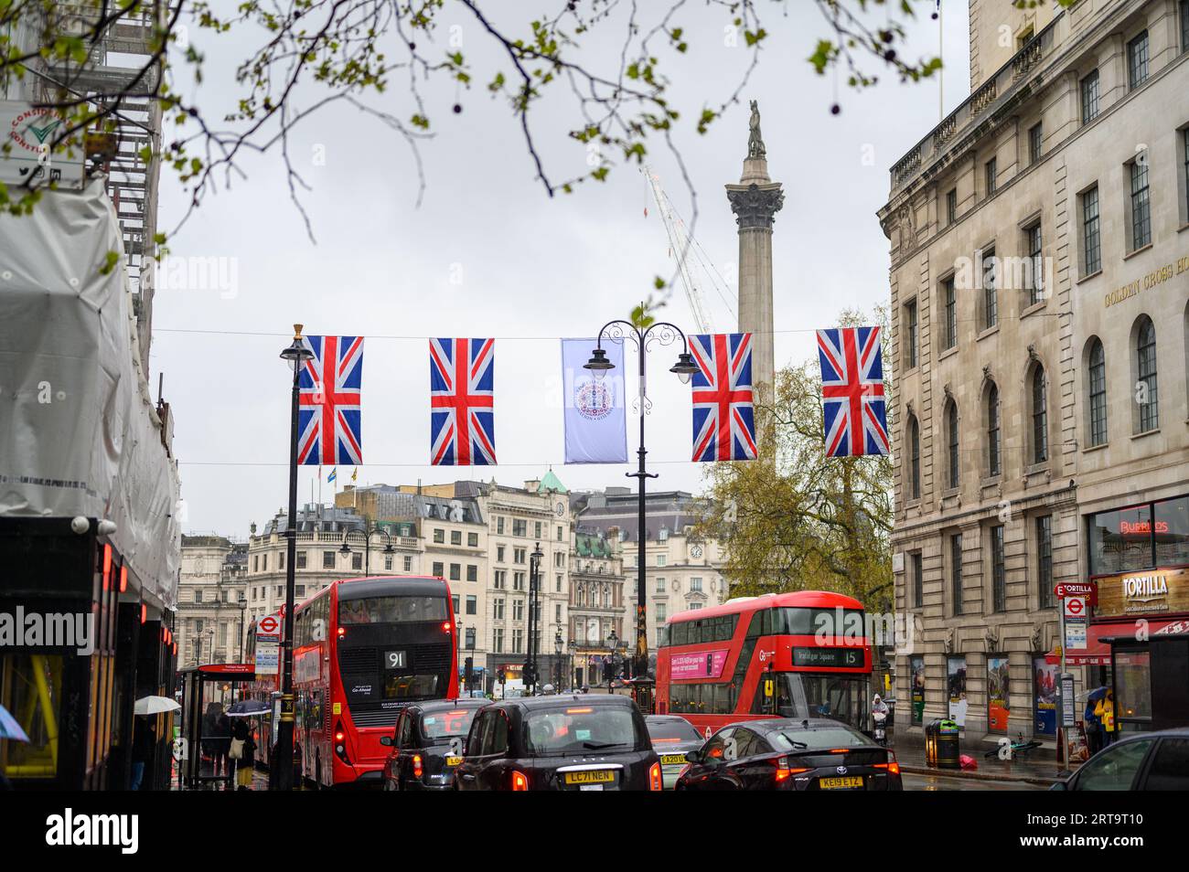 LONDON - April 24, 2023: Classic black taxi cabs and red London double ...