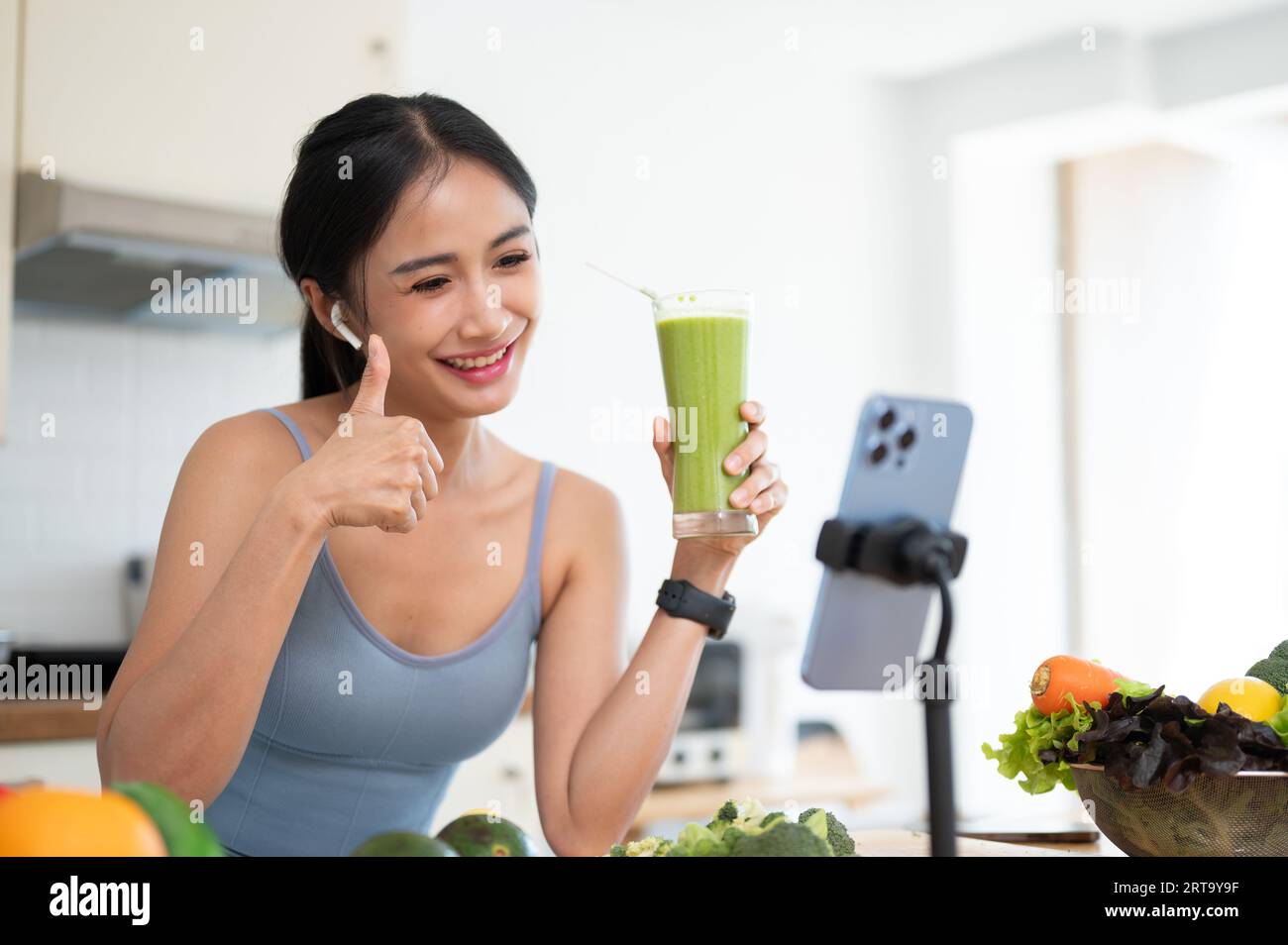 An attractive Asian female influencer or online nutrition coach is ...