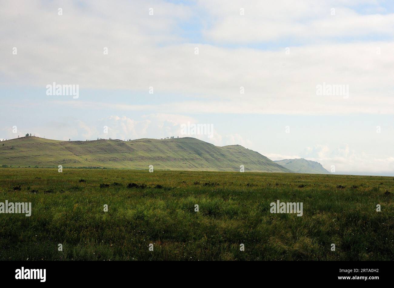 A range of high mountains with rocky formations on the edge of a huge ...
