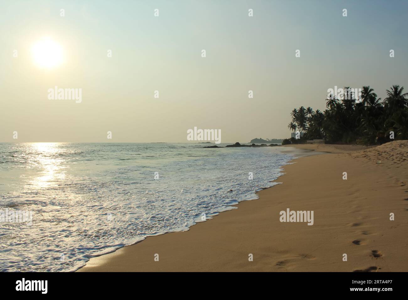Beach with golden sand and blue ocean water on most popular unawatuna ...