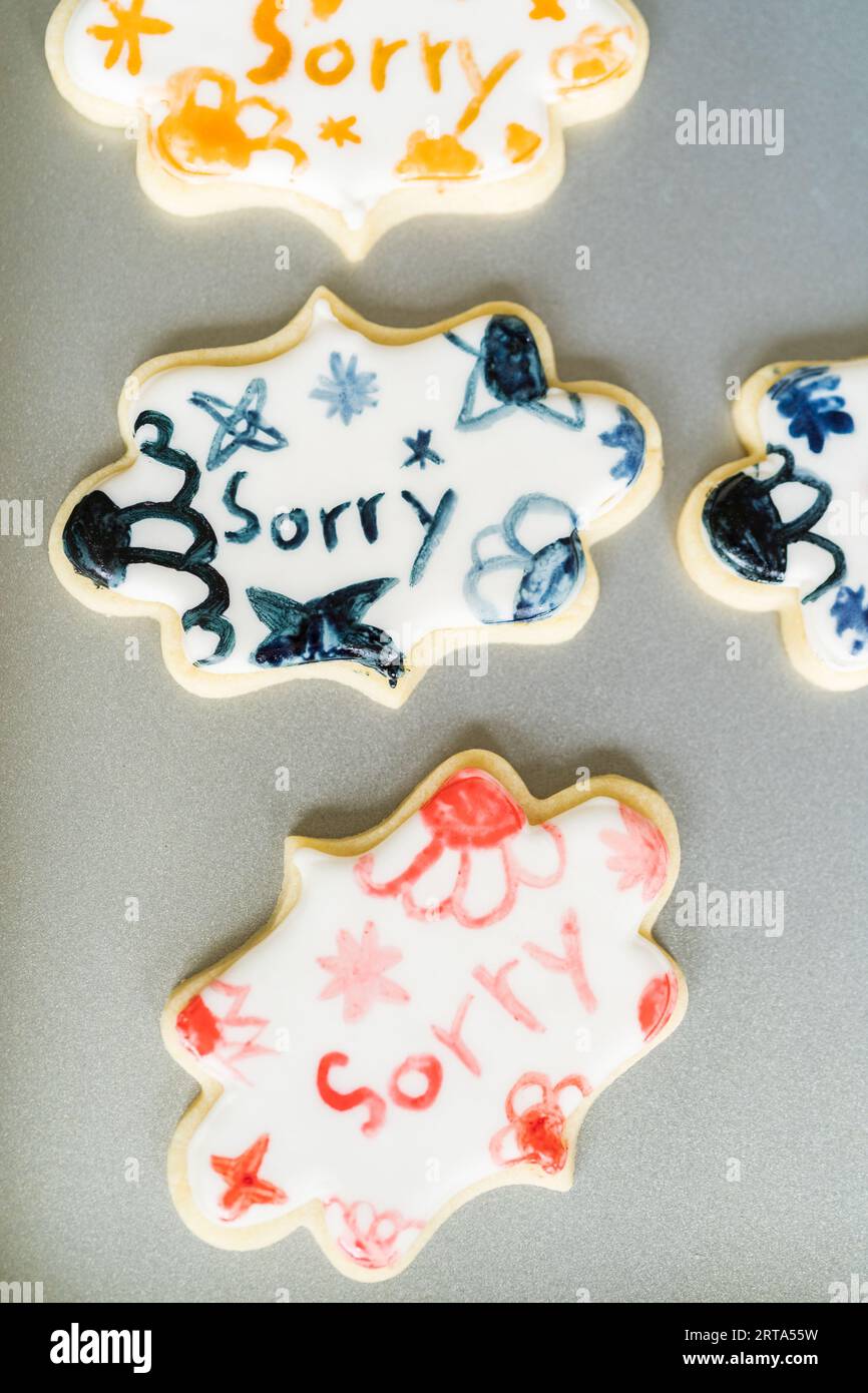 Little Girl Spells 'Sorry' on Iced Sugar Cookies Stock Photo - Alamy