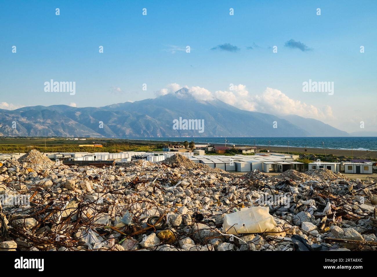 The sea is seen over the piles of rubble. Mileyha Wetland is a place ...