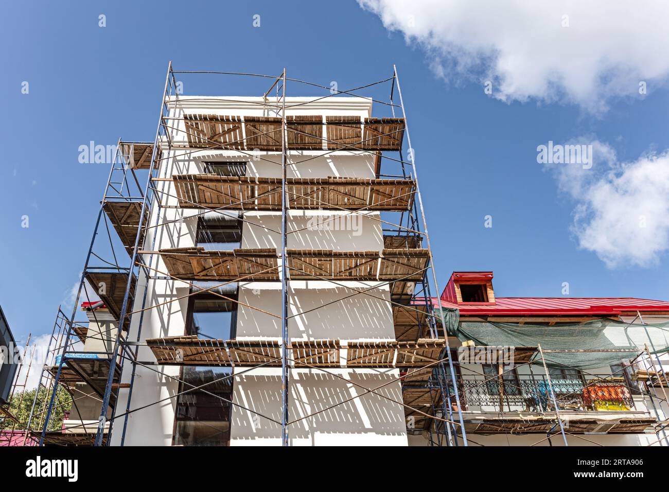 old building under reconstruction. scaffolding near facade of a ...