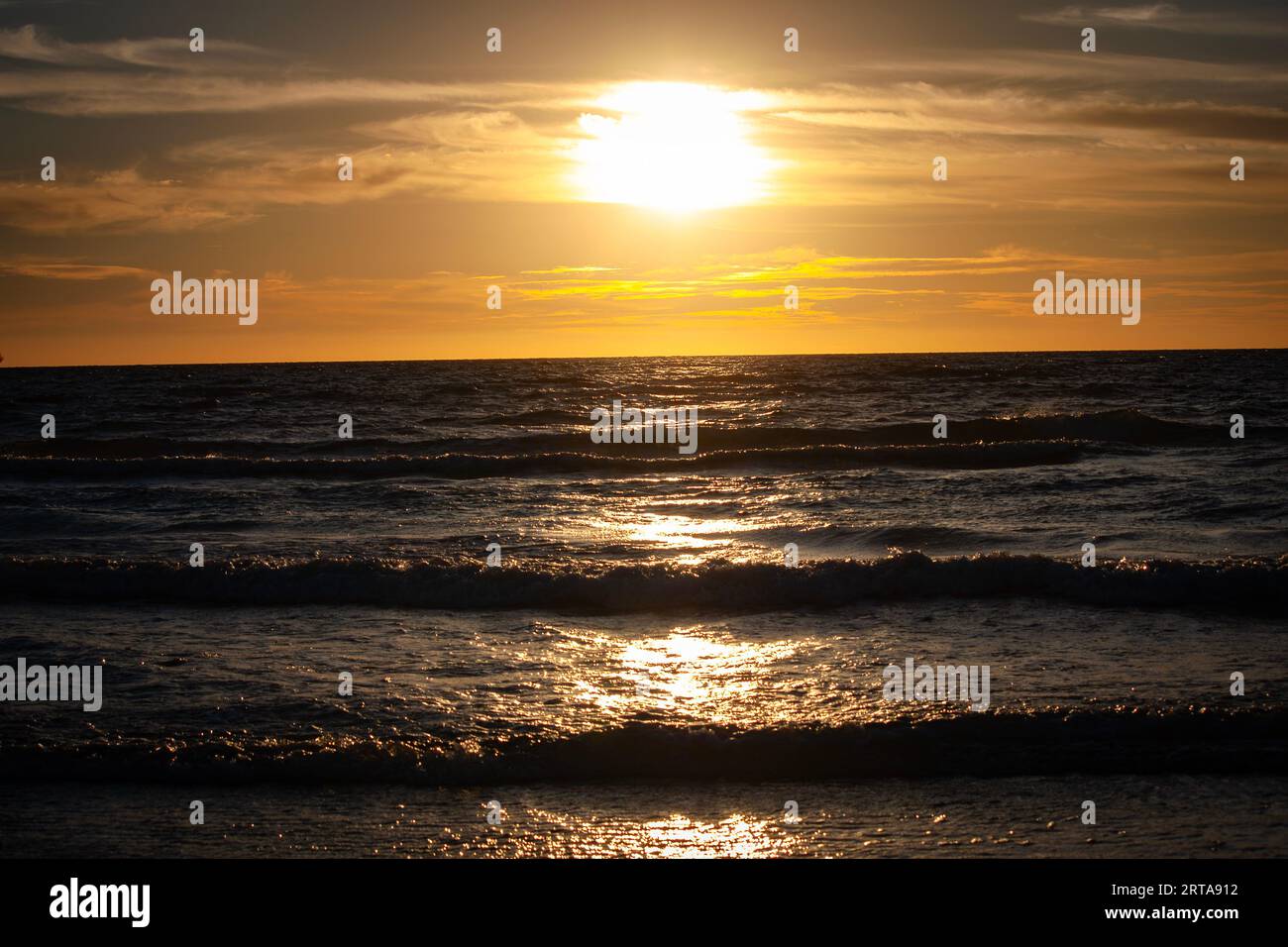 Grange beach at dusk on a calm and cloudy evening with lapping waves ...