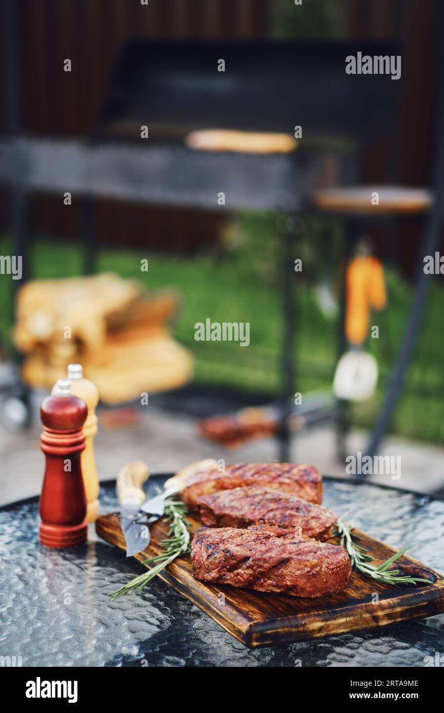 Grilled beef steak on backyard Stock Photo - Alamy