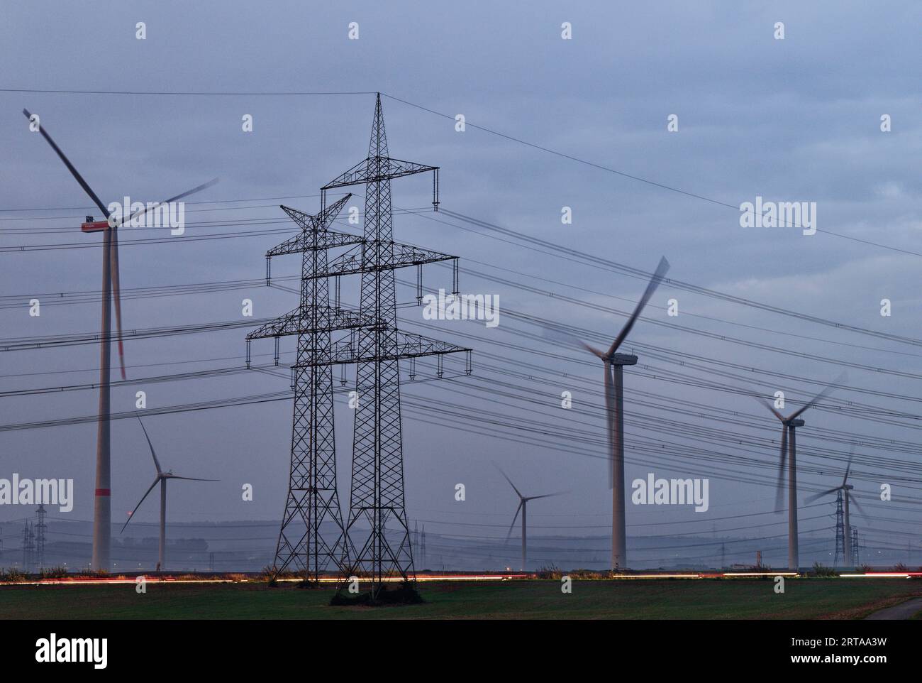 Cologne, Germany. 12th Sep, 2023. A high-voltage power line and wind ...