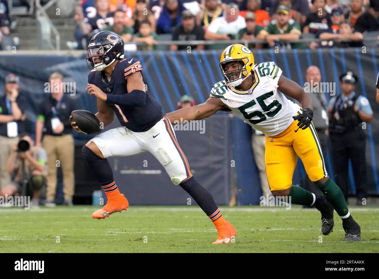 Chicago Bears quarterback Justin Fields runs past Green Bay Packers linebacker Kingsley Enagbare ...