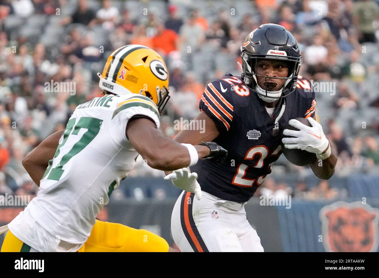 Chicago Bears running back Roschon Johnson carries the ball as Green ...