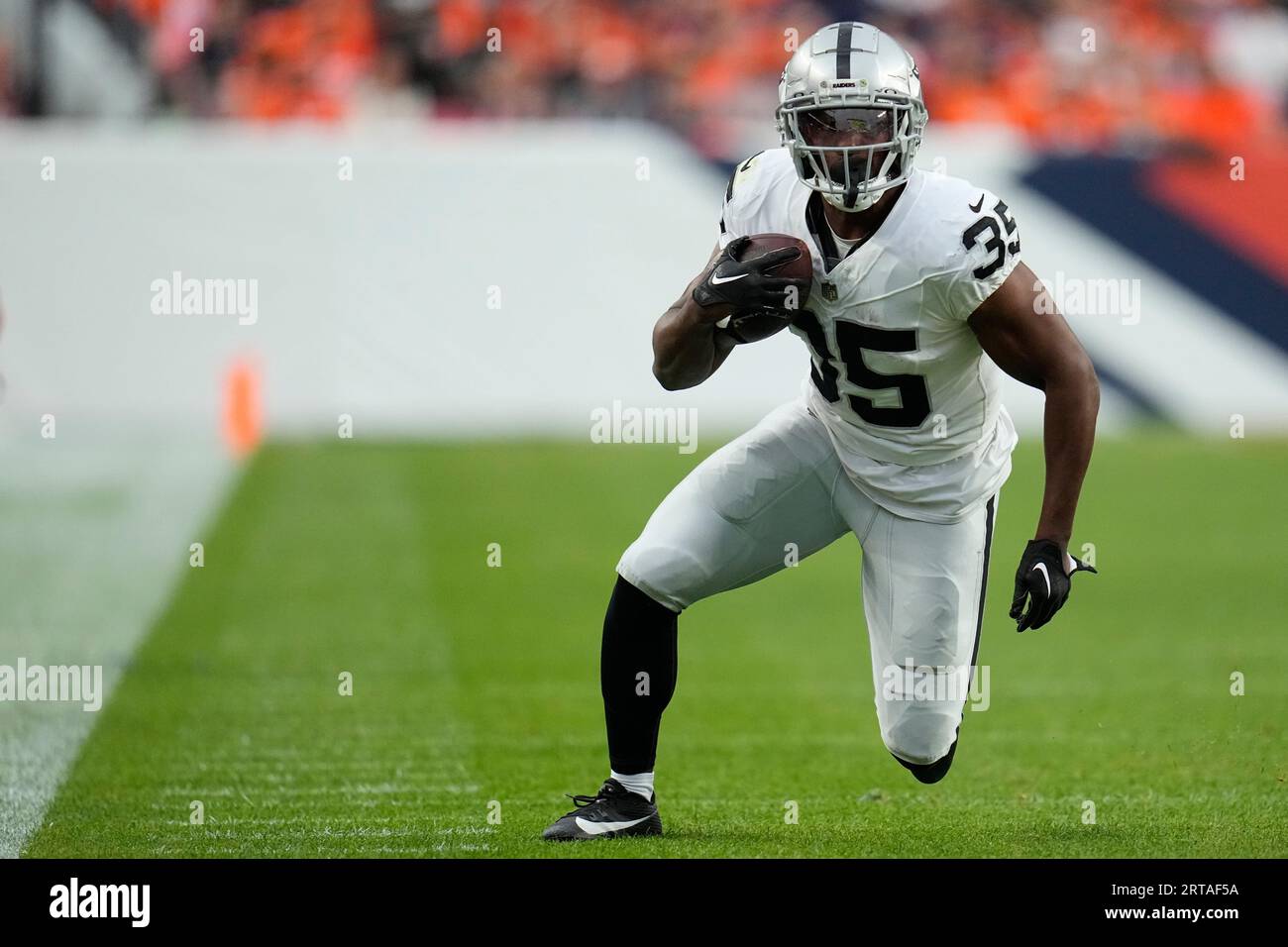 Las Vegas Raiders running back Zamir White (35) runs against the Denver ...